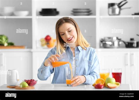 Beautiful Woman Preparing Fresh Juice In Kitchen Stock Photo Alamy