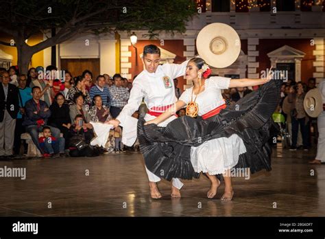 Male And Female Dancers In Traditional Costume Performing La Marinera