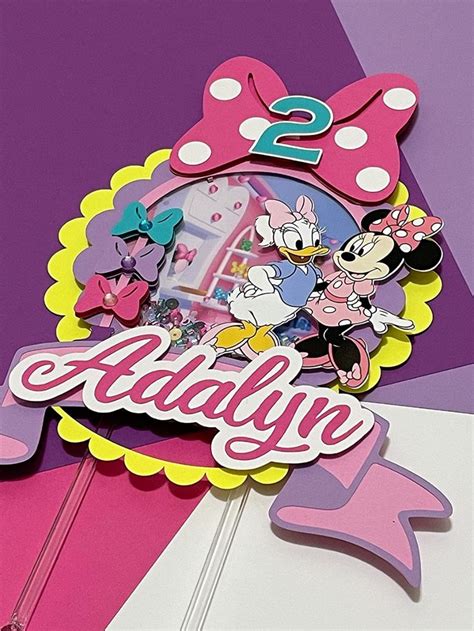 A Minnie Mouse Birthday Cake Topper With The Number Two On It S Side