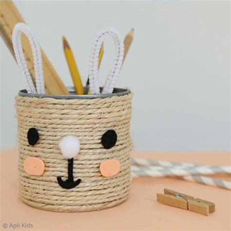A Close Up Of A Cup On A Table With Scissors And Pencils In It