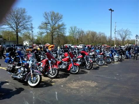 A Large Group Of Motorcycles Parked In A Parking Lot