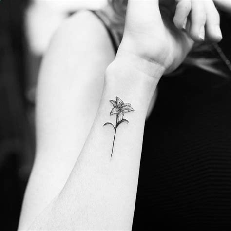 24 Symbolic Lily Tattoo Ideas Flower Wrist Tattoos Lily Flower
