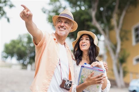 Premium Photo Man Pointing While Woman Holding Map