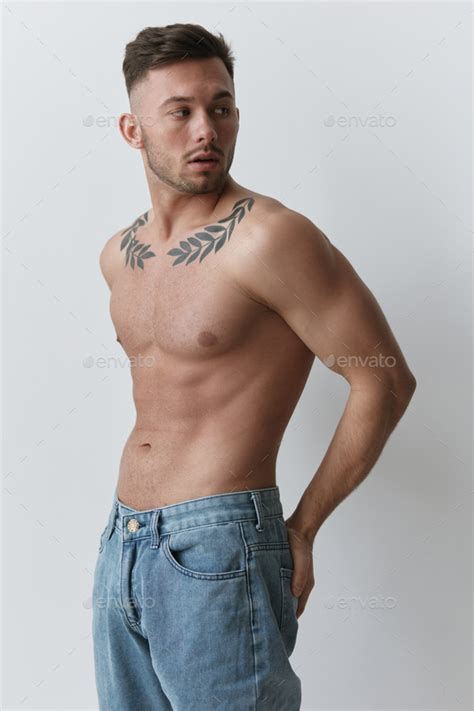 Sporty Sexy Muscular Handsome Naked Man Holds Hands On Belt Looks Aside