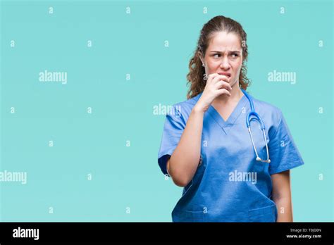 Young Brunette Doctor Girl Wearing Nurse Or Surgeon Uniform Over Isolated Background Looking