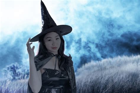 Premium Photo Asian Witch Woman With A Hat Standing With The Night