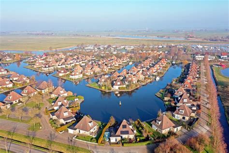Aerial From A Typical Dutch Landscape Houses And Water In Friesland