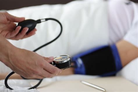 O paciente está deitado na cama sua pressão arterial é medida
