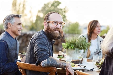 Portrait Of Man At Dinner Party With Friends Outdoors Del Colaborador