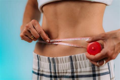 Premium Photo Women Measuring Her Waist With Tape Measure