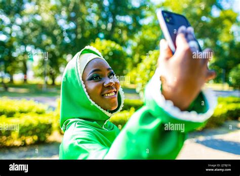 Latin Hispanic Arab Woman In Green Muslim Dress With Modern Bright Make Up And Nose Piercing