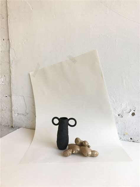 A Black And White Sculpture Sitting On Top Of A Table Next To A Piece