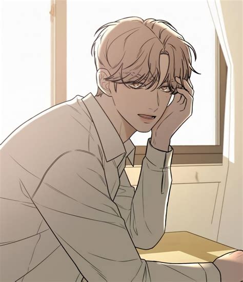 A Man Sitting At A Desk With His Head In His Hands