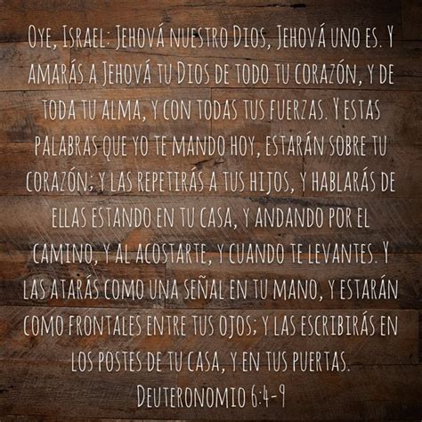 A Wooden Wall With A Bible Verse Written In White On The Bottom And An