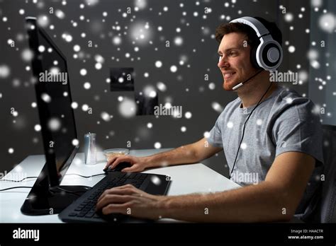 Man In Headset Playing Computer Video Game At Home Stock Photo Alamy