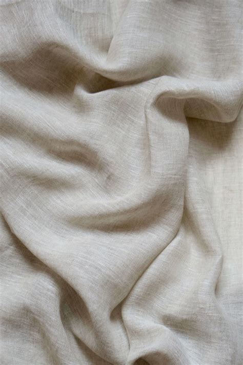 An Unmade Bed With White Sheets On Top Of It