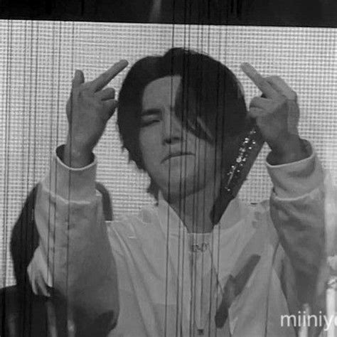 A Man Holding His Hands Up In The Air