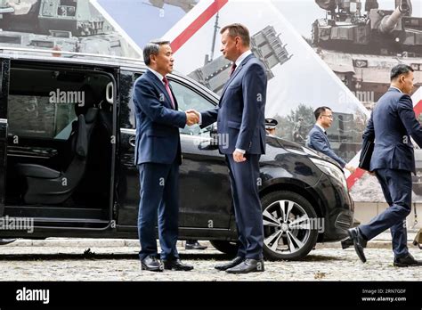 Polish And Korean National Flags Wave As Mariusz B Aszczak Minister Of