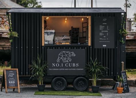 A Black Food Truck With No 1 Cubs Written On It S Side And Plants In