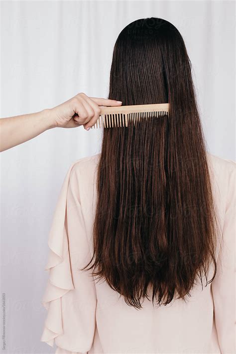 Anonymous Woman Combing Hair By Stocksy Contributor Serge Filimonov