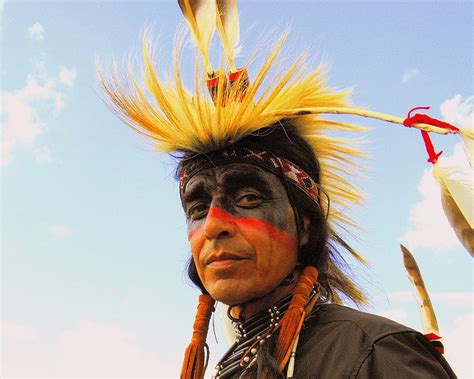 A Native American Man With Feathers On His Head
