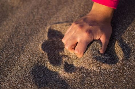 Premium Photo Hand Of Unrecognizable Brunette Latina Woman Grabbing Sand From The Dunes Of A