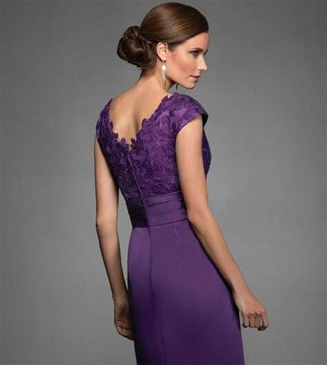 A Woman In A Purple Dress Is Looking Down At Her Shoulder And The Back