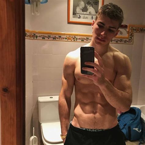 A Shirtless Man Taking A Selfie In Front Of A Bathroom Mirror With His