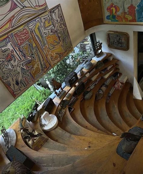 An Aerial View Of A Wooden Staircase In A Building With Paintings On