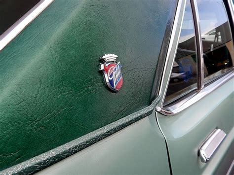 An Emblem On The Side Of A Green Car