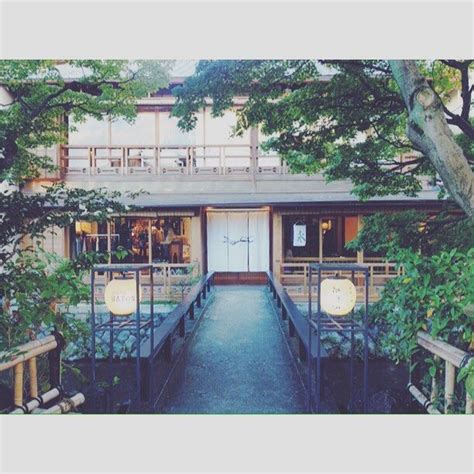 The Entrance To An Apartment Building Surrounded By Trees
