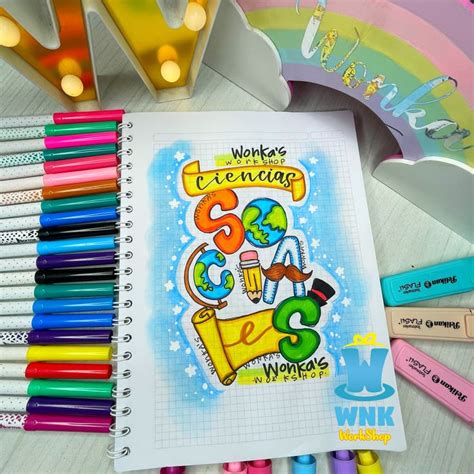 There Is A Notebook With Markers And Pens On The Table Next To Some