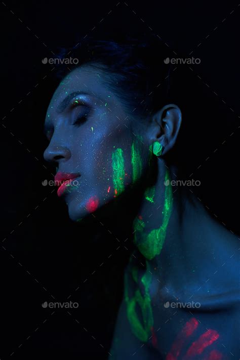 Sexy Nude Woman In Neon Light UV Paint On The Woman Face And Body