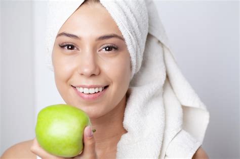 Premium Photo Beautiful Girl With Perfect White Teeth Holding Green