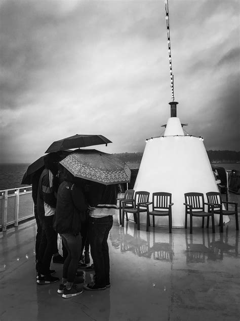 Tourists Huddle Under Umbrellas On The Argosy Cruise Seattle