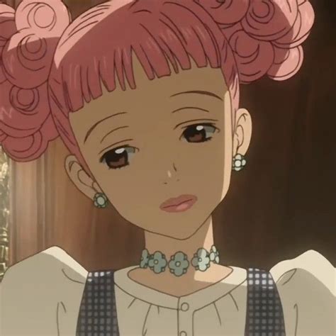 An Anime Character With Pink Hair And Large Earrings On Her Head