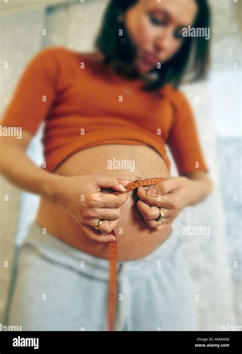 Pregnant Woman Measuring Her Belly Stock Photo Alamy
