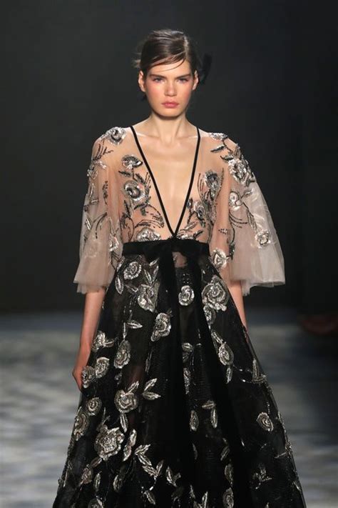 A Model Walks Down The Runway In A Black And White Dress With Sheer