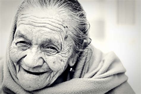 Download Mature Old Woman Smiling At The Camera Wallpaper
