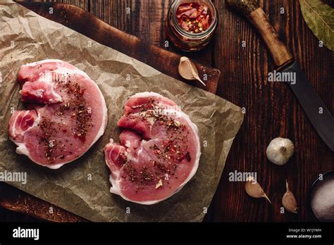 Raw Pork Loin Steaks With Different Spices Stock Photo Alamy