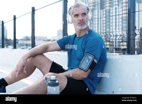 Tired Exhausted Middle Aged Man Resting After Running Outdoors