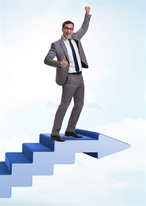Businessman Climbing Career Ladder In Business Concept Stock Photo