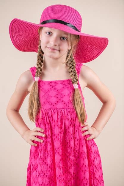 Premium Photo A Girl In A Pink Hat And Pink Dress