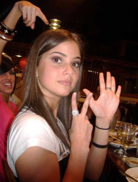 A Woman Making The Peace Sign With Her Fingers