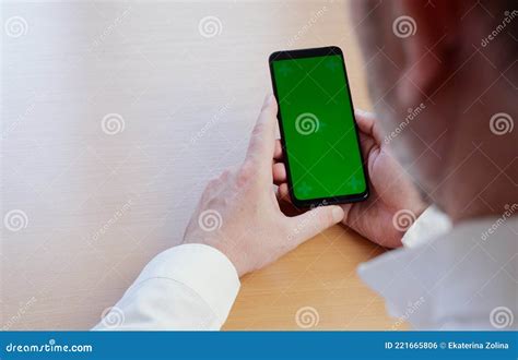 A Mock Up Image Of A Hand Man In A White Shirt Holding A Black Mobile