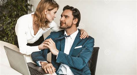 Businesswoman Seduces Office Worker Sitting At Desk Woman Pulls A Man For His Tie Seducing A