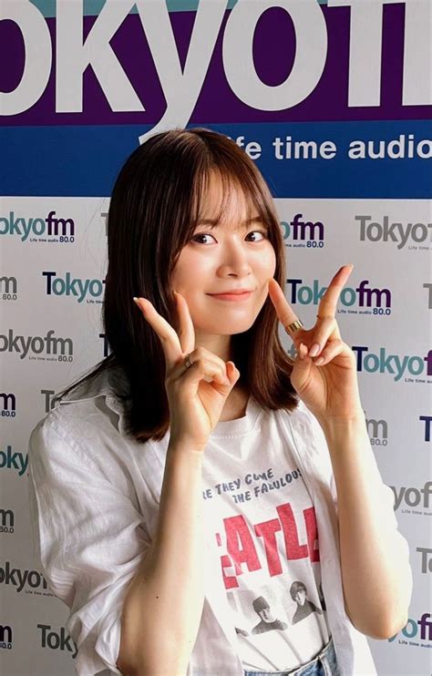 A Woman Holding Up Two Fingers In Front Of Her Face