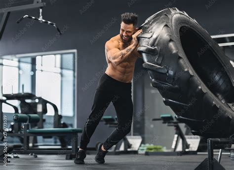 Naked Man Flipping Huge Tire At Gym Stock Photo Adobe Stock