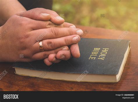 Praying Hands With Bible Background