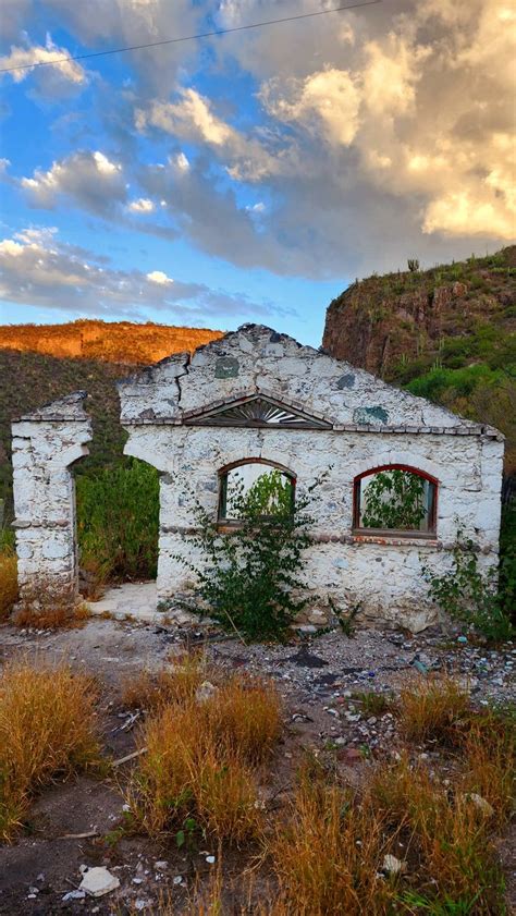 An Old Run Down Building In The Middle Of Nowhere With No Roof Or